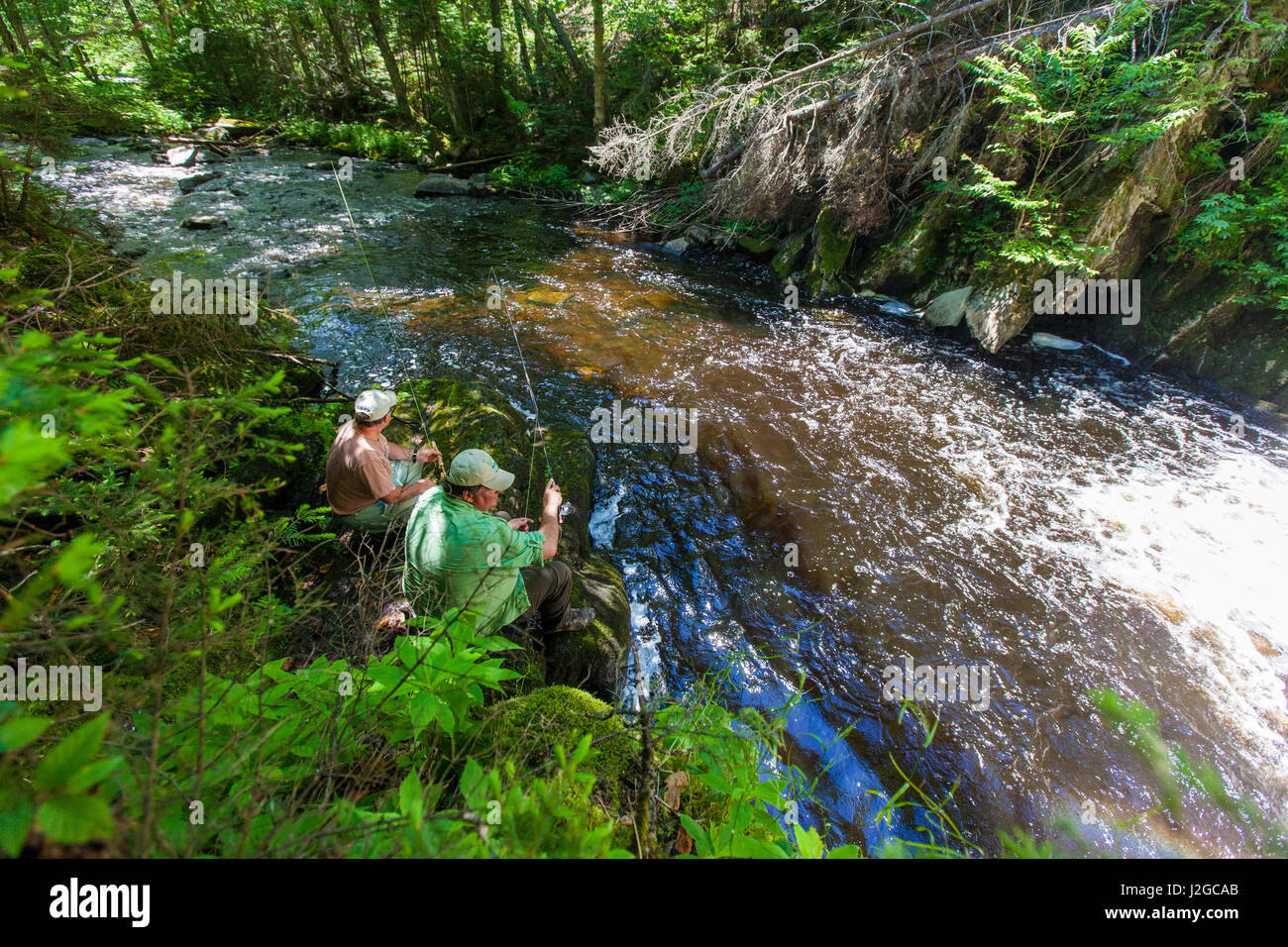 Two men fly-fishing below Cold Stream Falls in Maine's Northern Forest ...