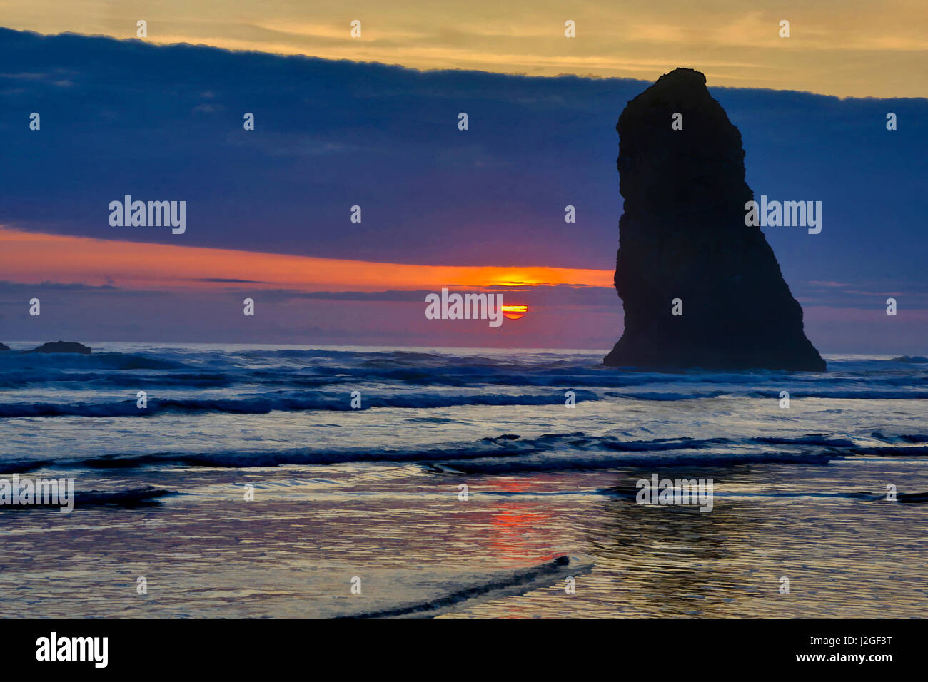 USA, Oregon, Cannon Beach. Sunset on lone seastack. Credit as: Jean ...