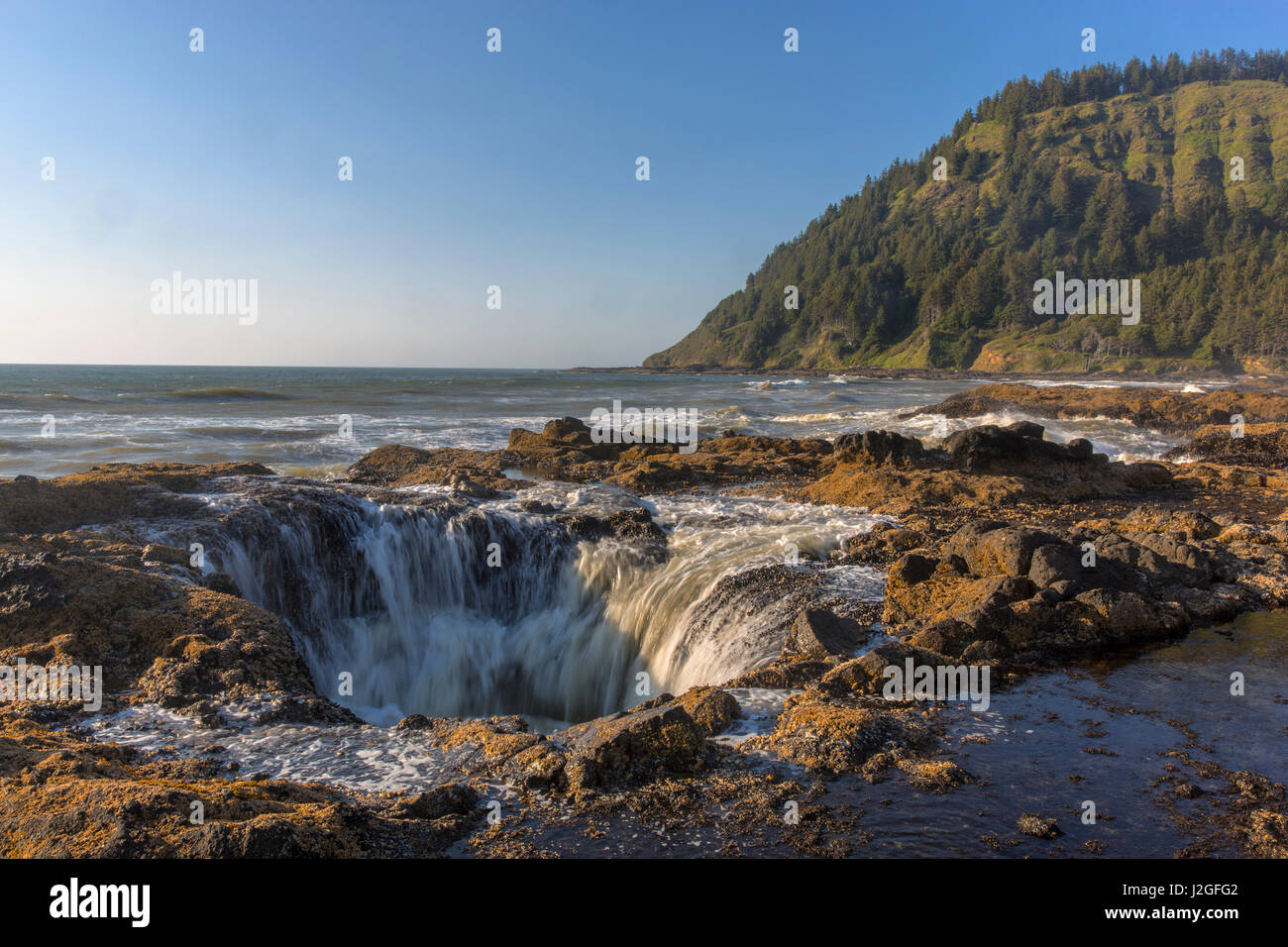 Waves churn at Thor's Well along the rugged Pacific Coast shore at Cape ...