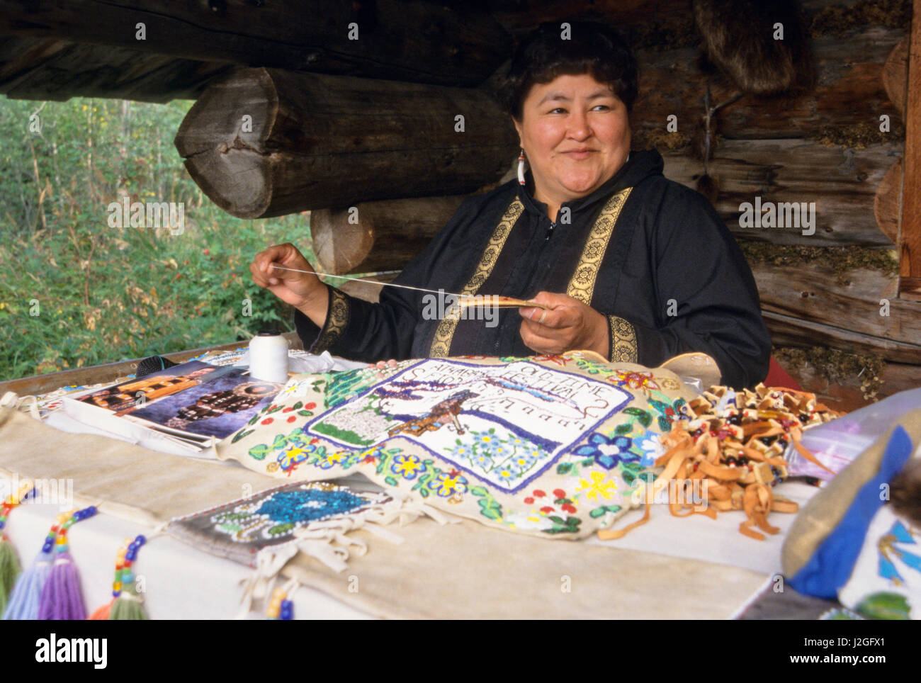 Athabaskan woman demonstrates traditional crafts such as sewing ...