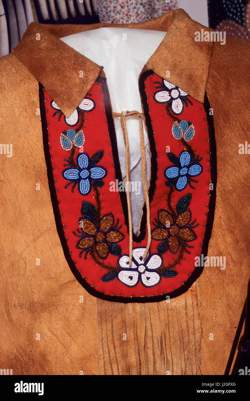 Floral patterns of beadwork decorate the front of a traditional ...