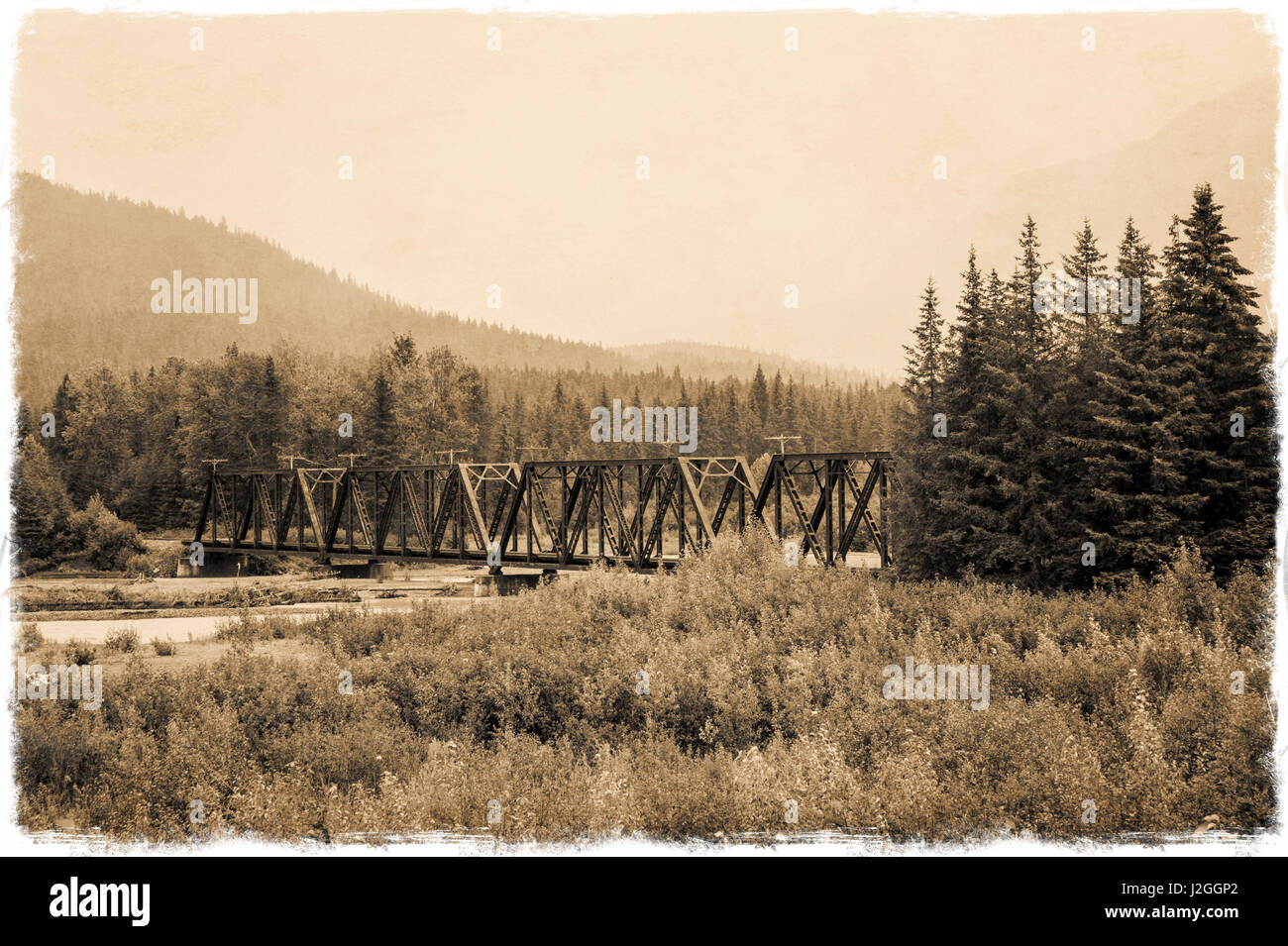 An iron rail crossing bridge in vintage sepia, Alaska Stock Photo - Alamy
