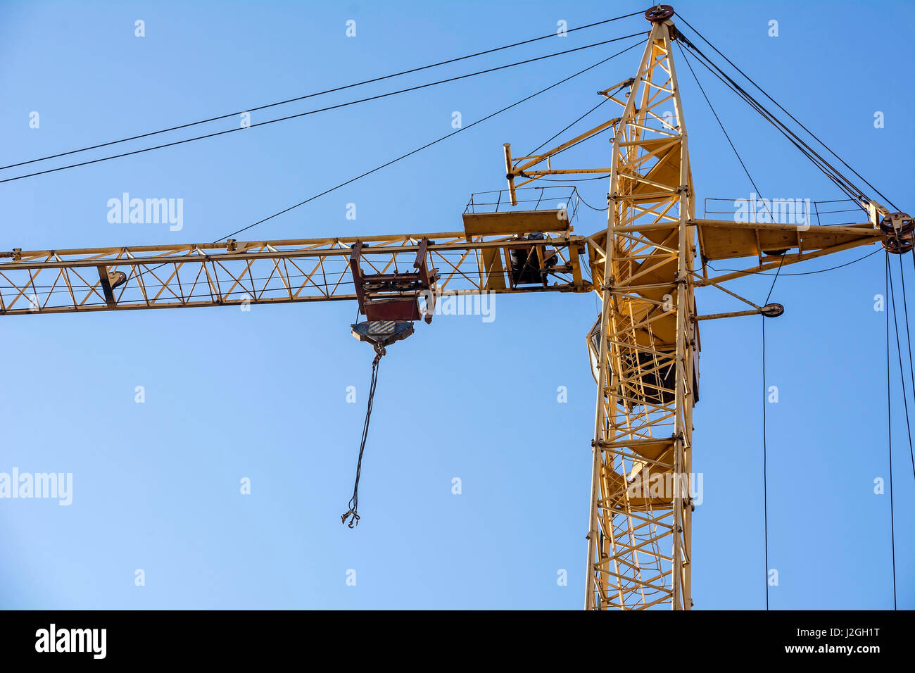 yellow construction crane on a background of blue sky Stock Photo - Alamy