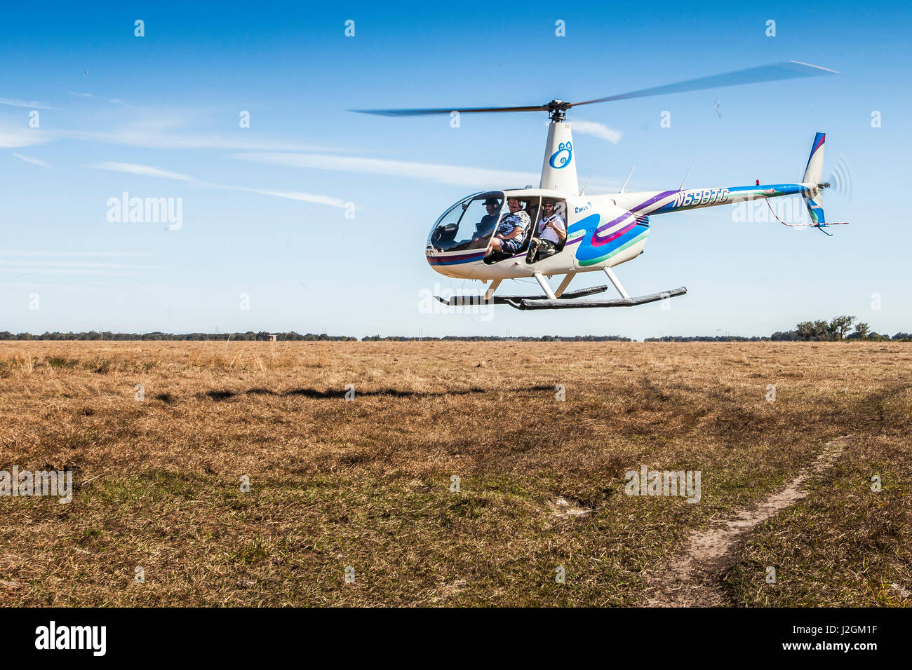 A private helicopter taking off in a open field in south central ...
