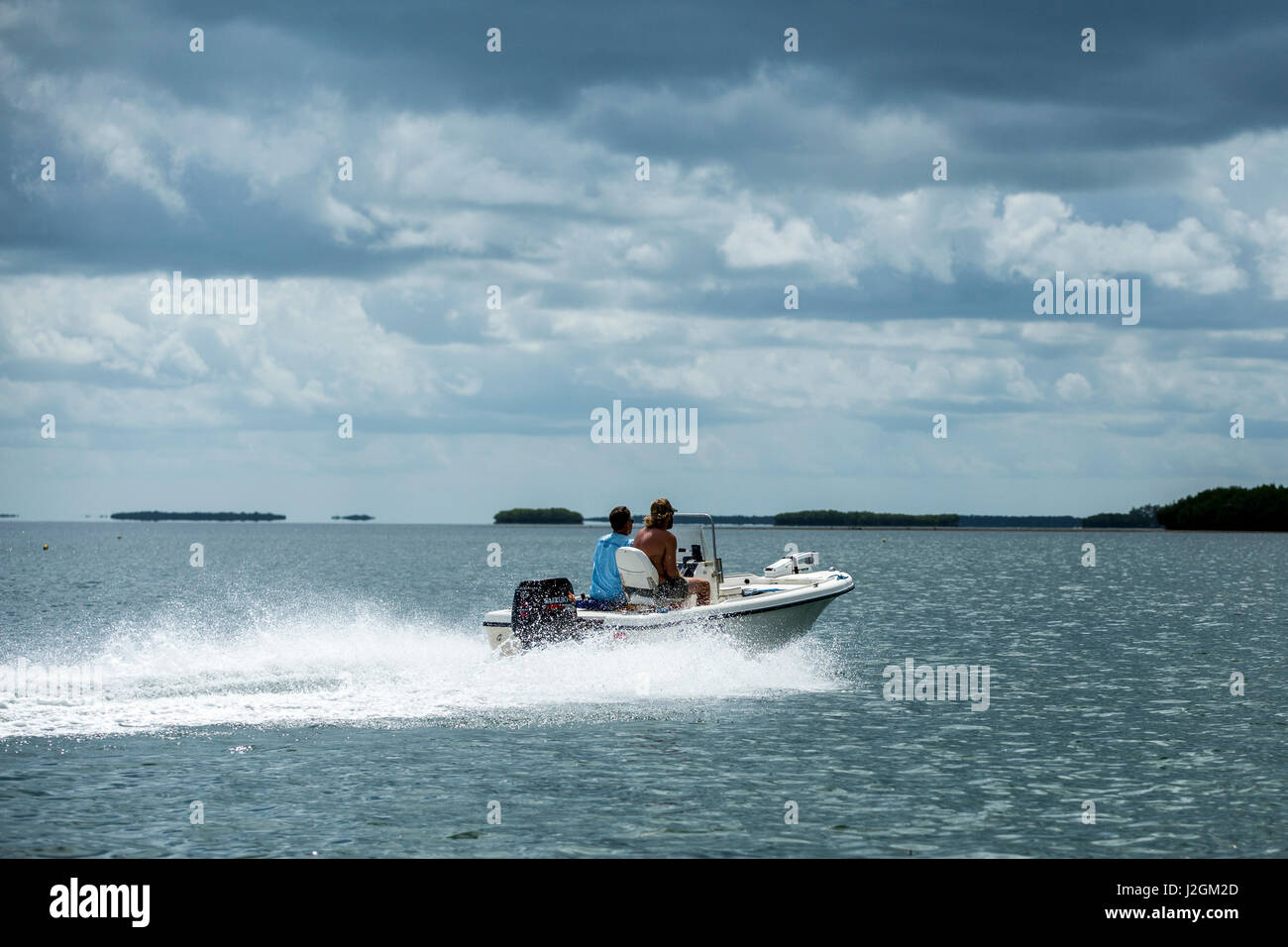 Fishermen drive their boat out to fishing grounds in Florida Bay to the ...