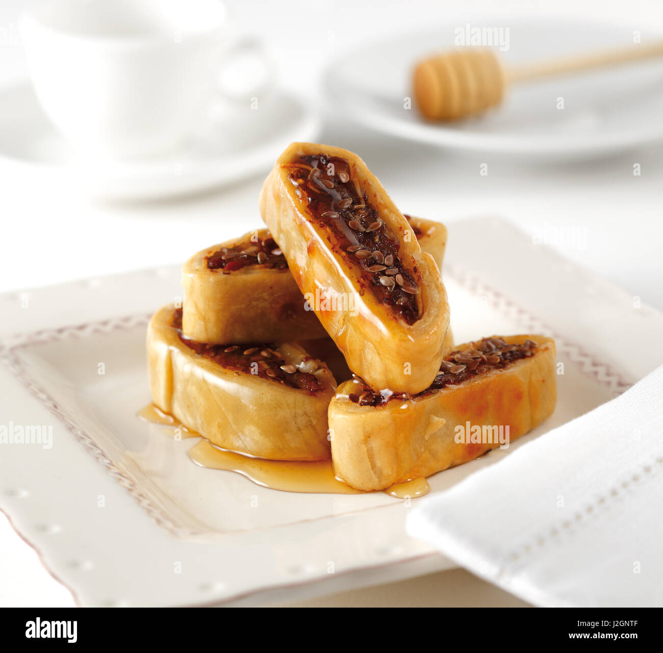 Sweet pastry stuffed with dates and covered with honey Stock Photo - Alamy