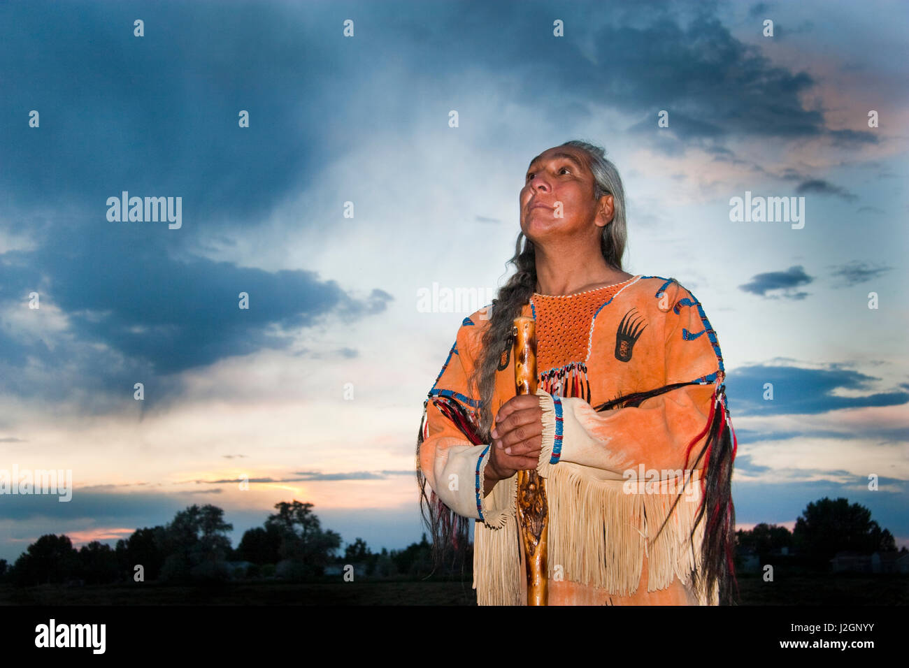 Native American medicine man dressed in ghost shirt uses a walking ...
