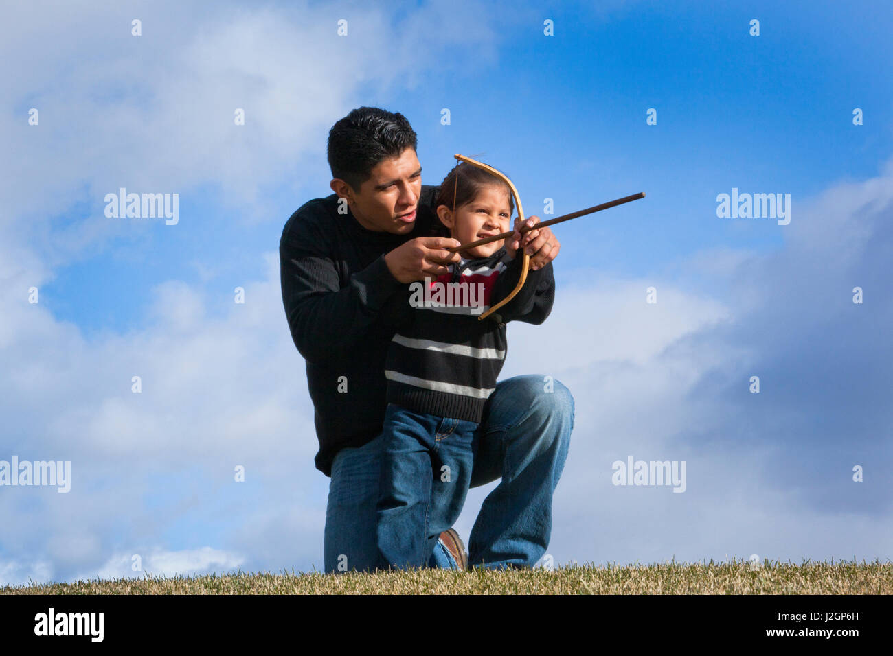 Outside a Native American father hands down tradition and teaches his 3 ...