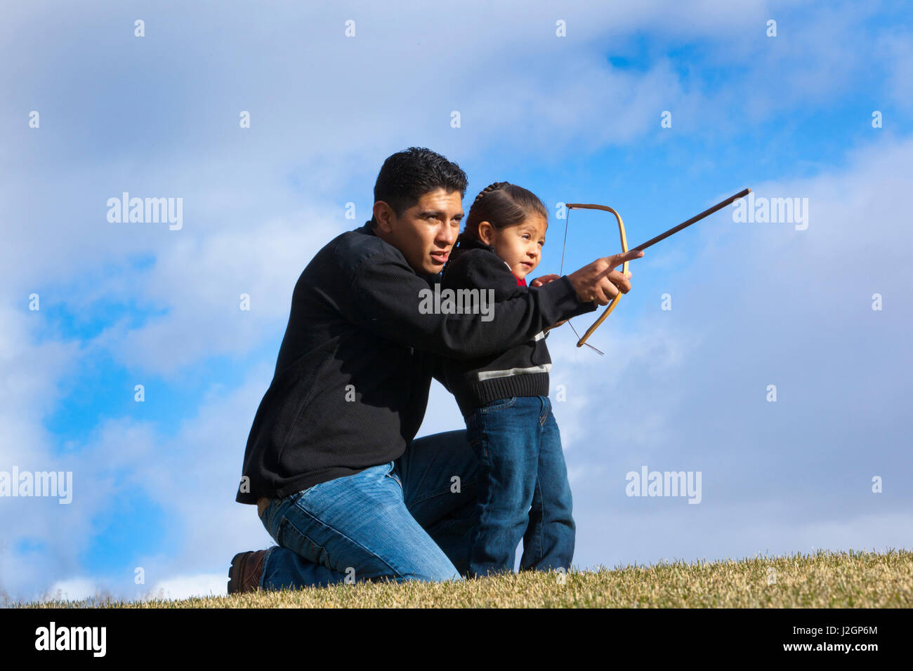 Outside a Native American father hands down tradition and teaches his 3 ...