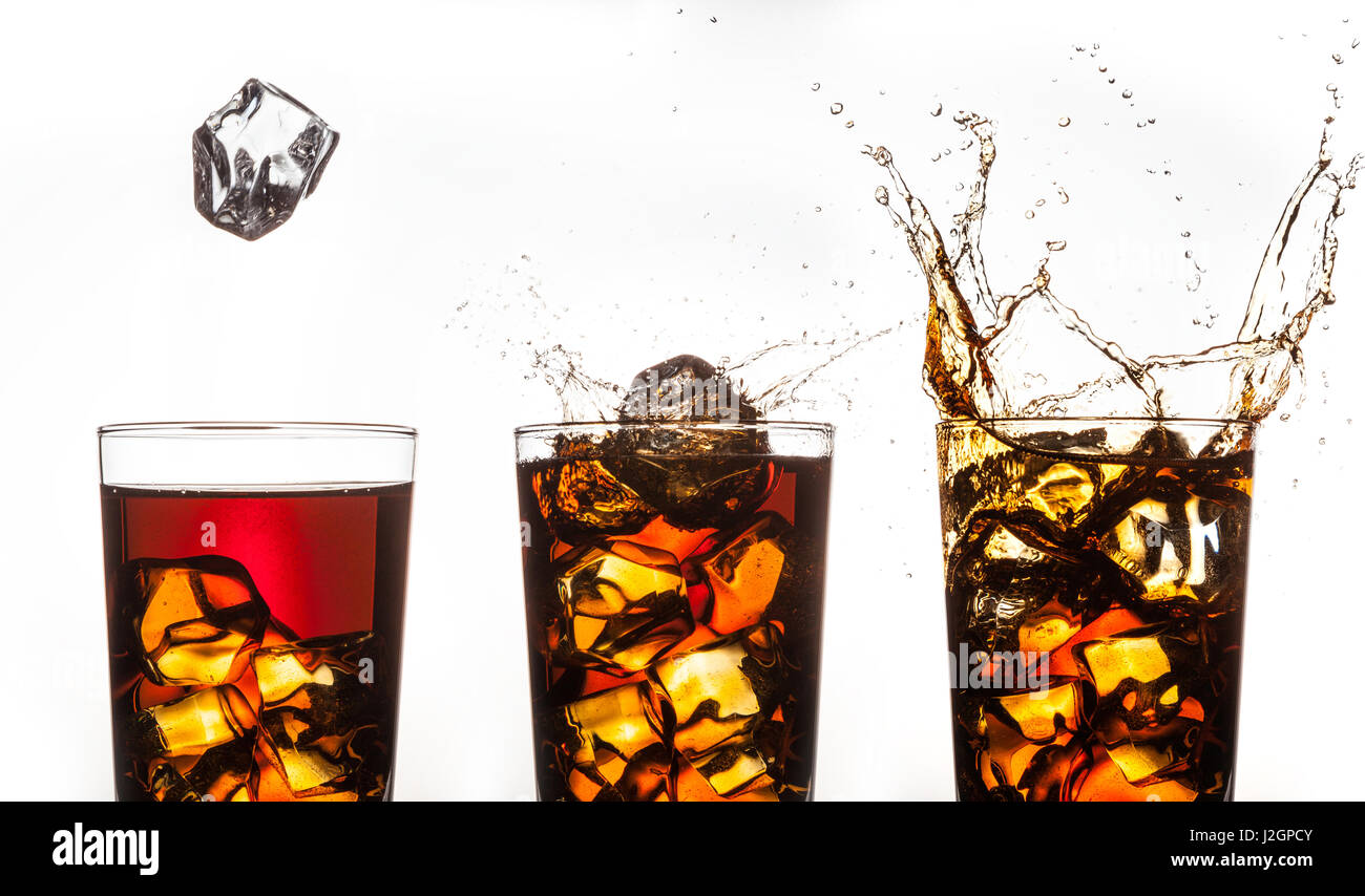 Ice dropping in cola drink splash sequence Stock Photo - Alamy