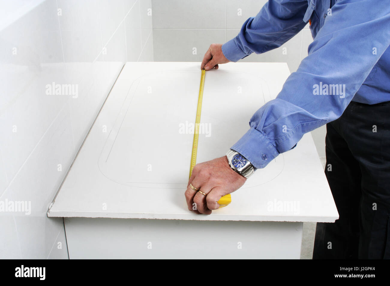 Construction worker taking measurements for the installation of a ...