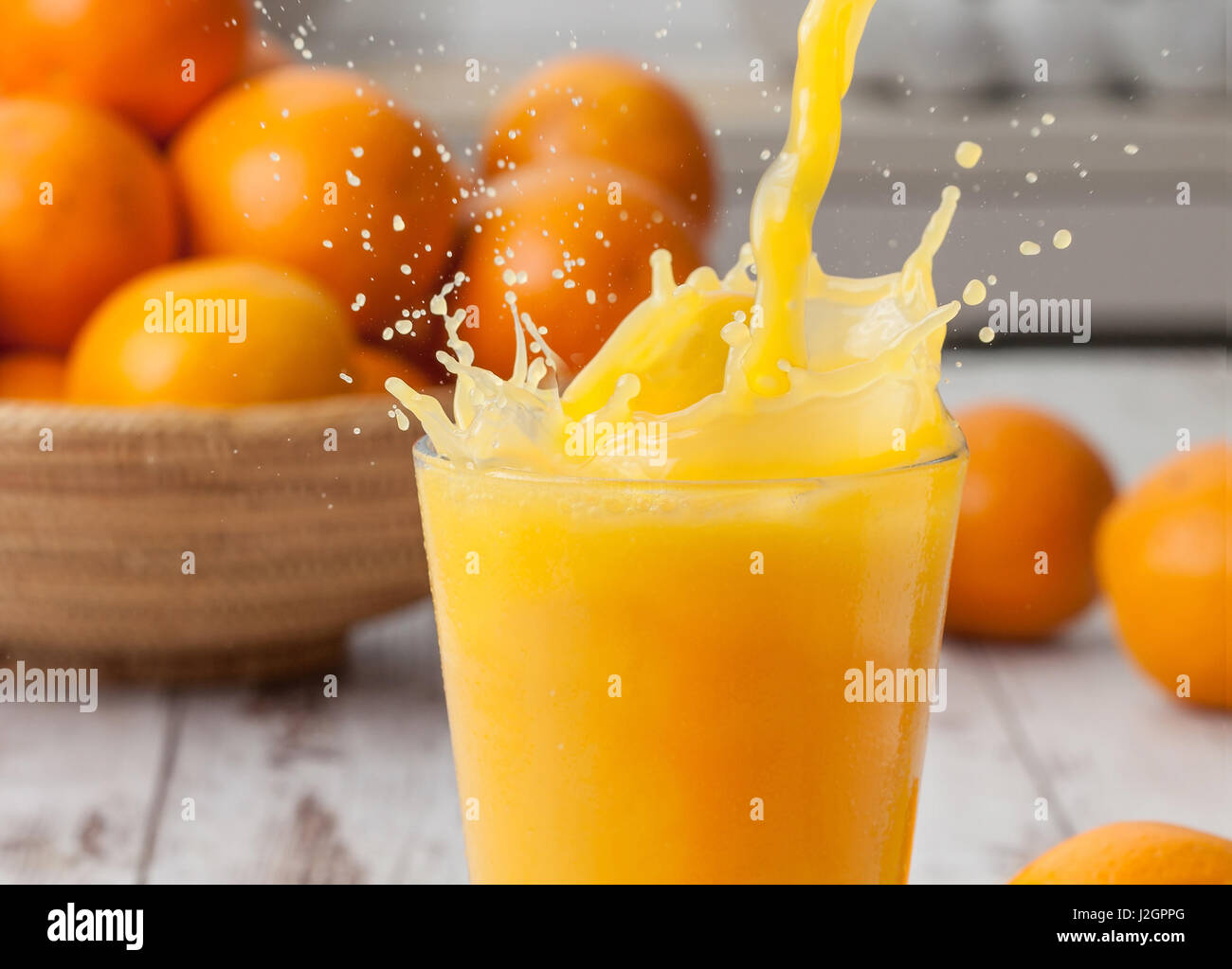 Pouring orange juice with splash Stock Photo - Alamy