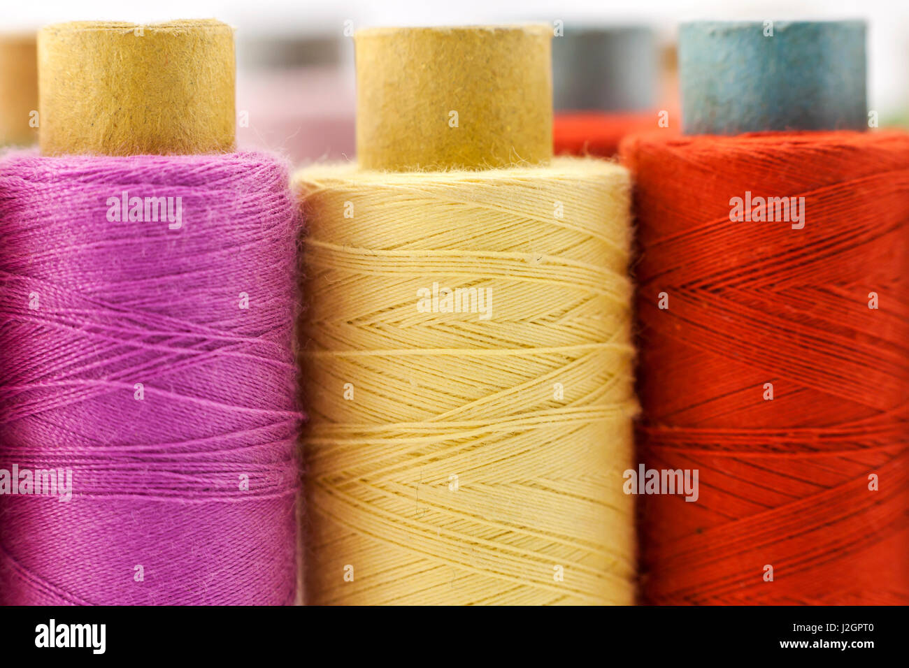 Reels or spools of multicolored sewing threads. Threads of all colors ...