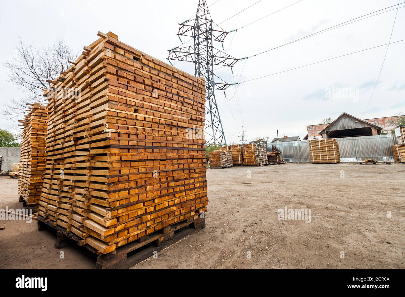 Stack of new wooden boards and studs at the lumber yard. Wooden plates ...