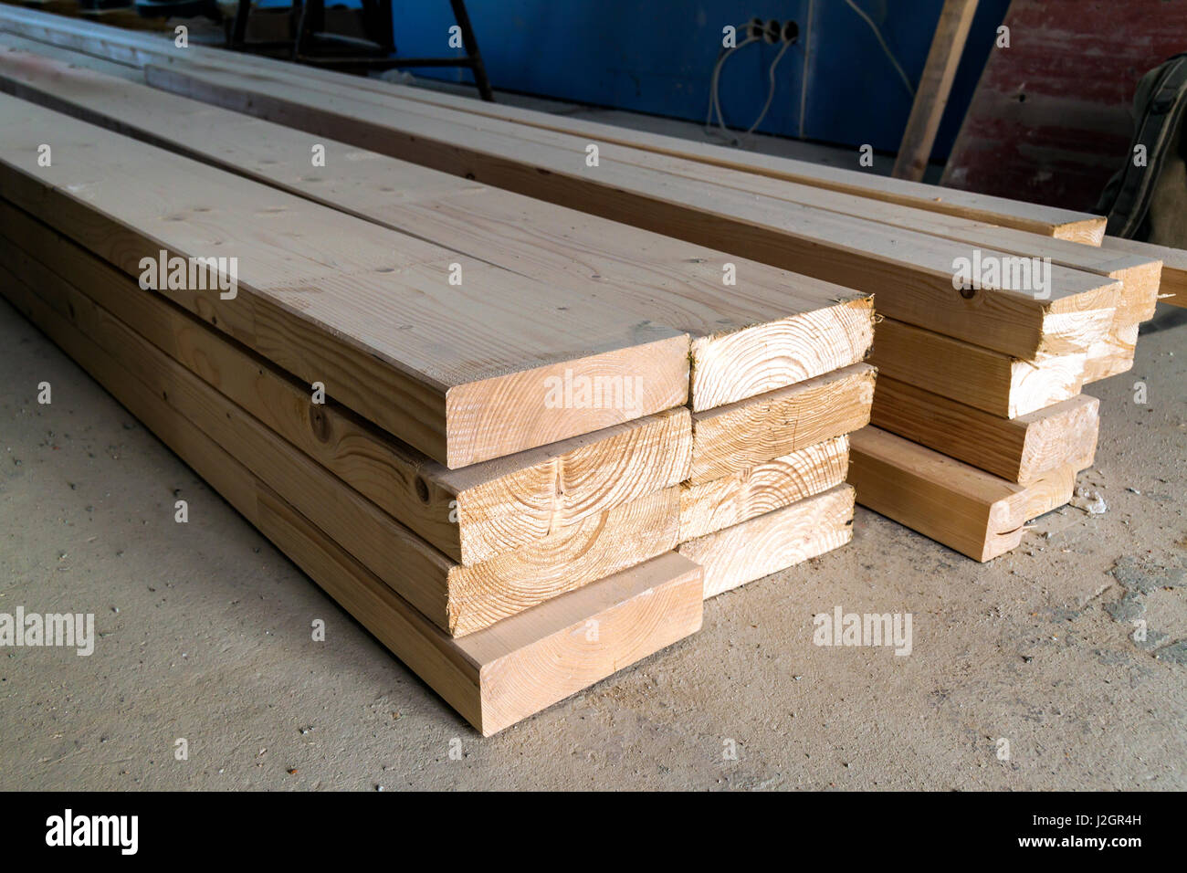 Stack of new wooden studs at the lumber yard. Wood timber construction ...