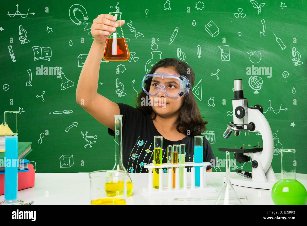 cute indian kids doing science experiment in chemistry lab or biology ...