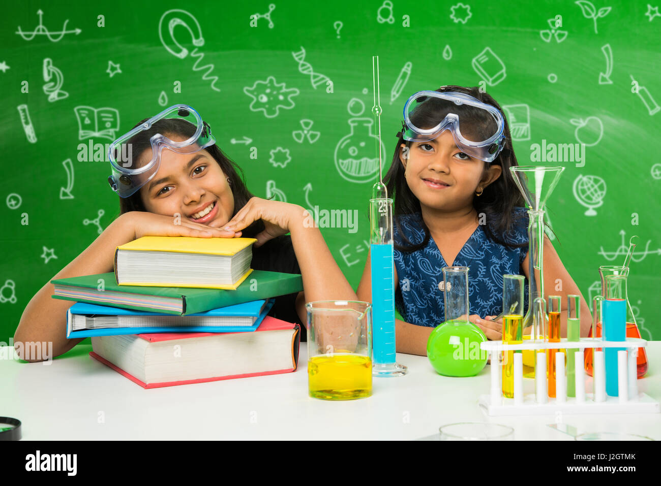 cute indian kids doing science experiment in chemistry lab or biology ...