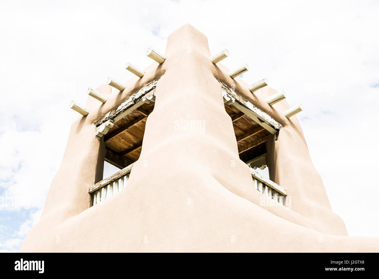 Looking up at the exterior of a tower on an adobe building, Taos, New ...