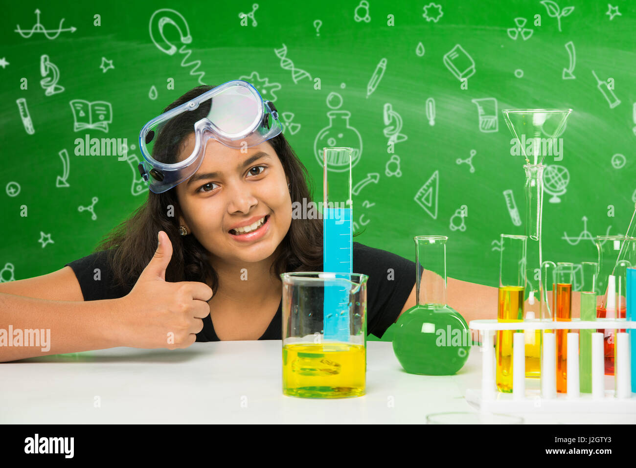 cute indian kids doing science experiment in chemistry lab or biology ...