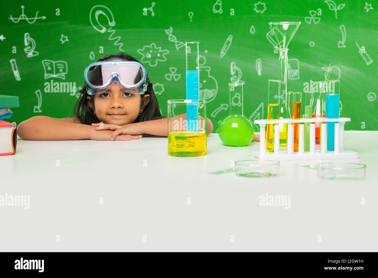 cute indian kids doing science experiment in chemistry lab or biology ...