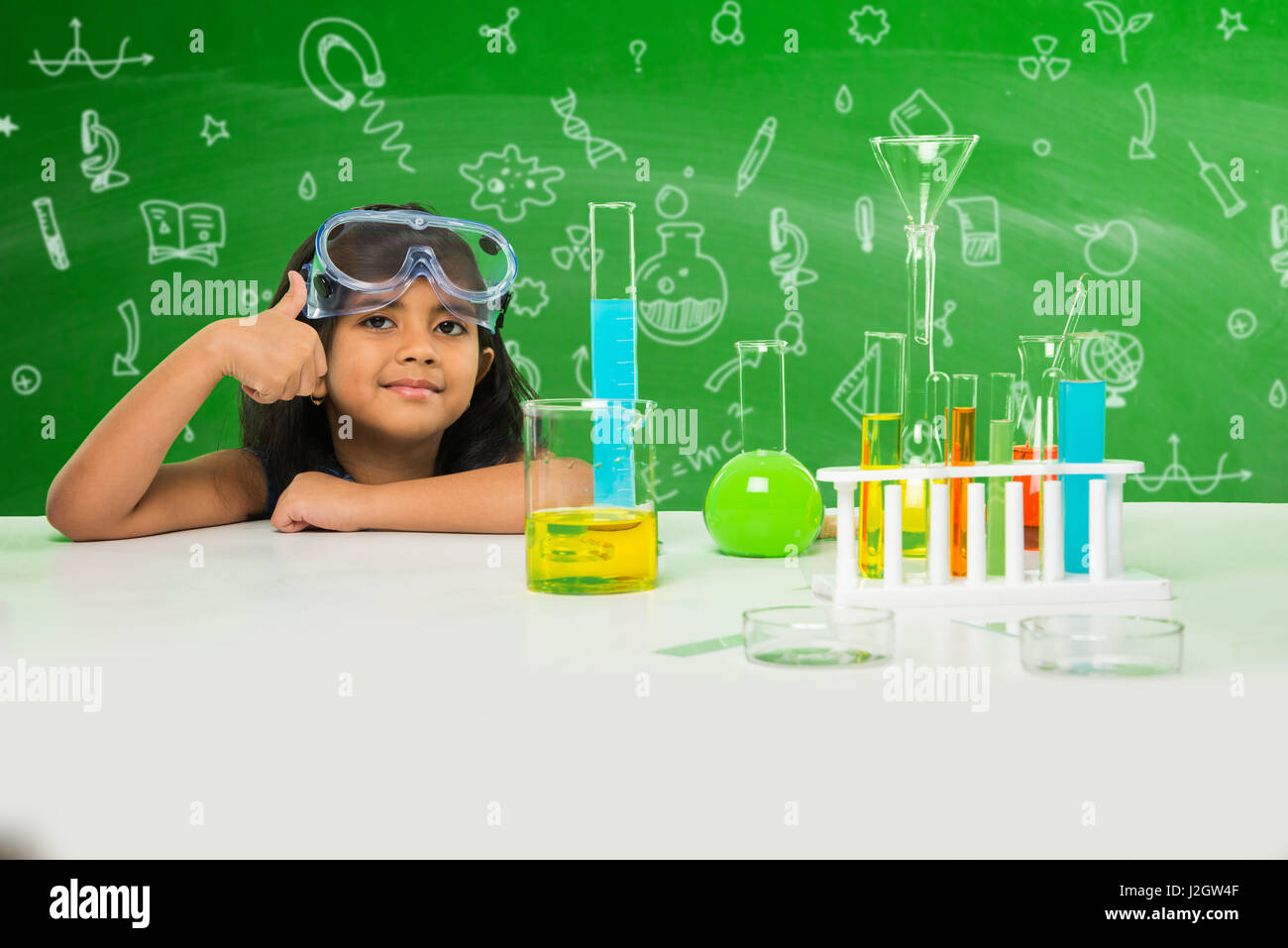 cute indian kids doing science experiment in chemistry lab or biology ...