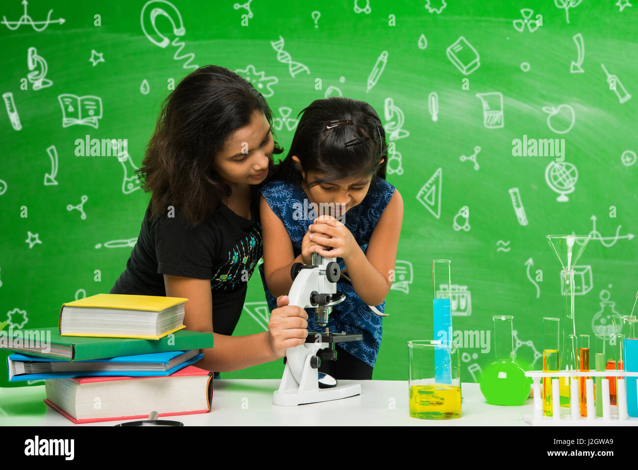 cute indian kids doing science experiment in chemistry lab or biology ...