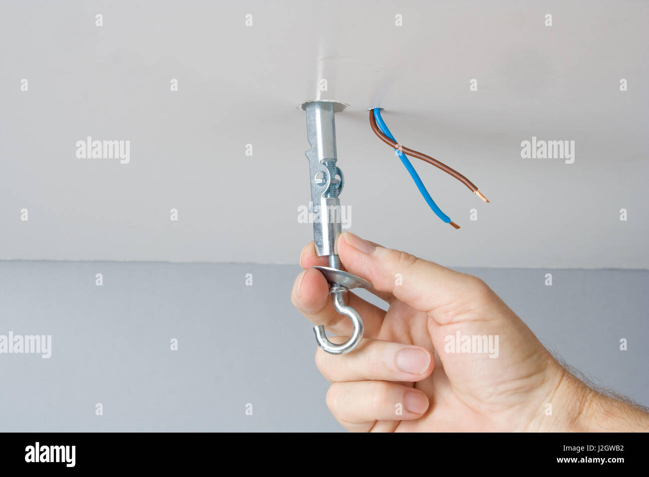 Introducing a toggle bolt for a light fixture Stock Photo - Alamy