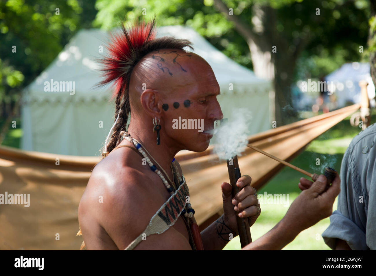 Native American Indian of the Northeastern Tribes takes a puff while ...