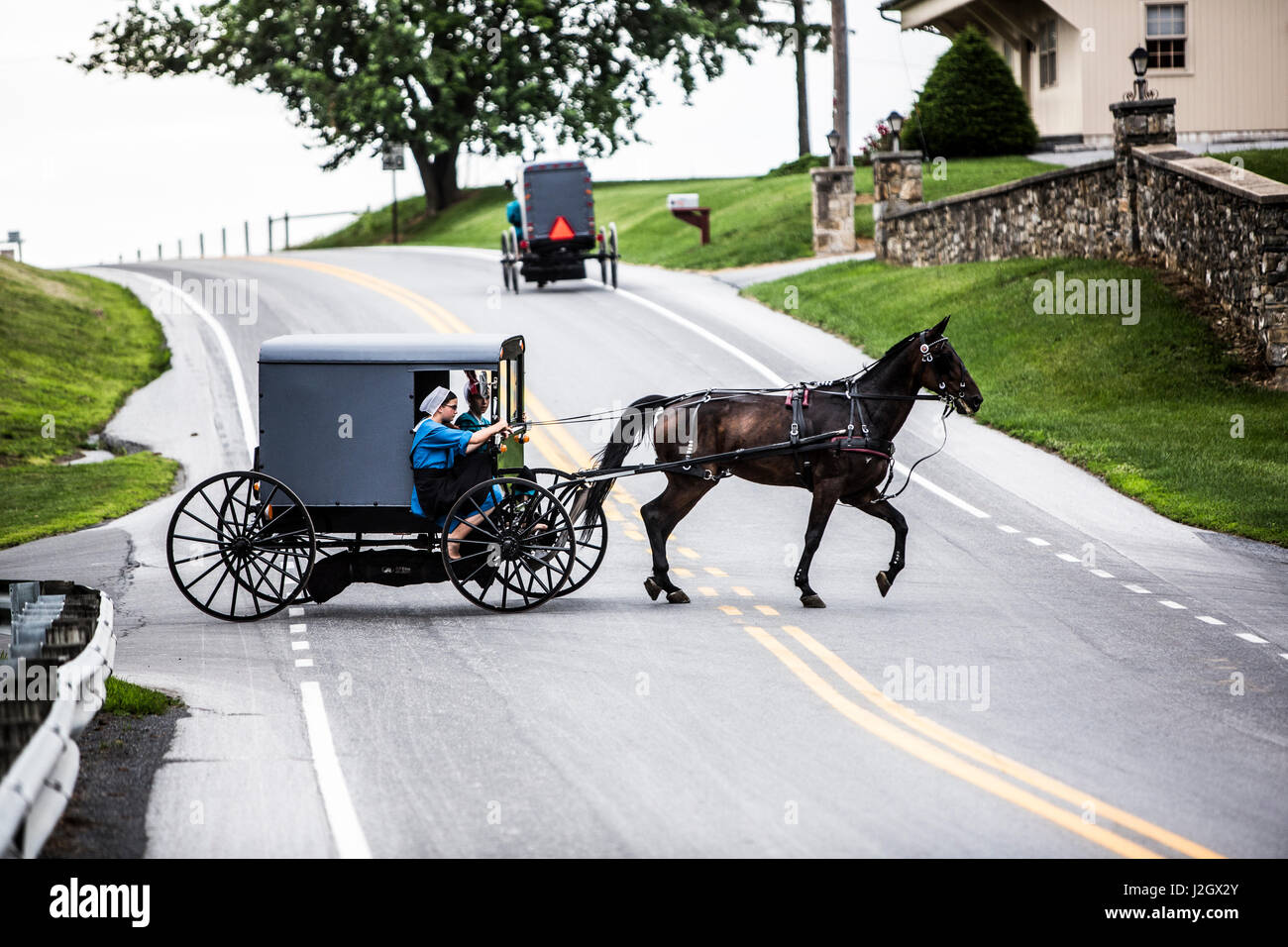 Lancaster County, Pennsylvania. Two Amish buggies, one with Amish girls ...
