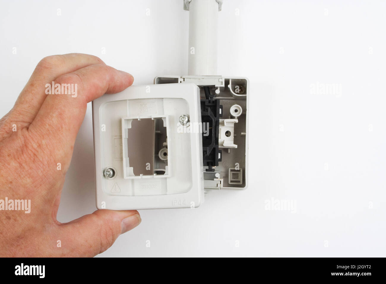 Installing a waterproof electrical switch for exterior use Stock Photo ...