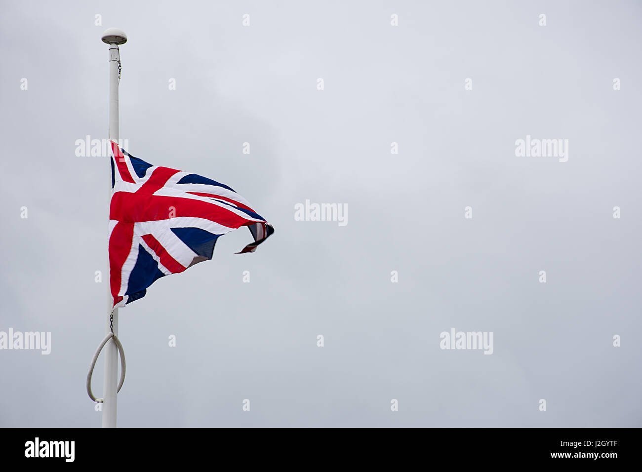 British flag , Union Jack waving on wind against grey ,cloudy sky Stock ...