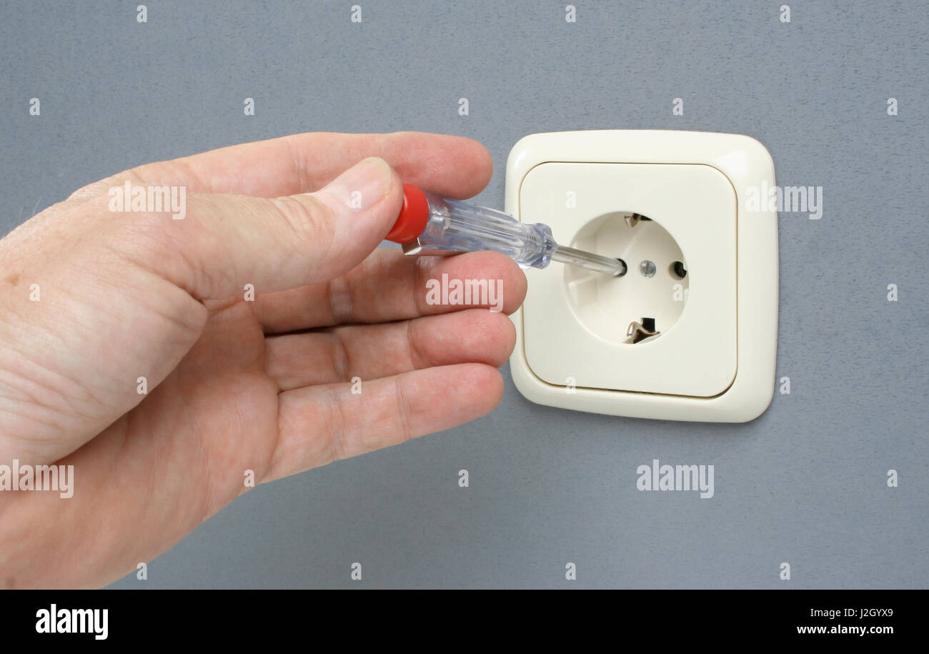 Checking if electrical wall outlet has voltage Stock Photo - Alamy