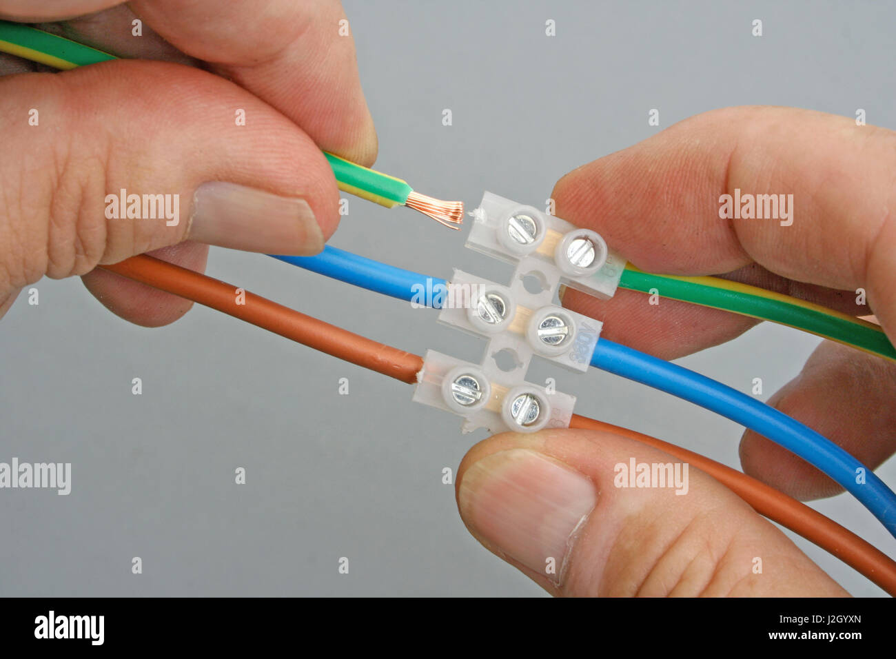 Closeup of hands holding a wire connector Stock Photo - Alamy