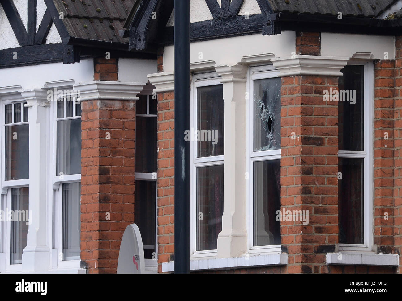 A shattered window at the scene in Harlesden Road, London, after a ...