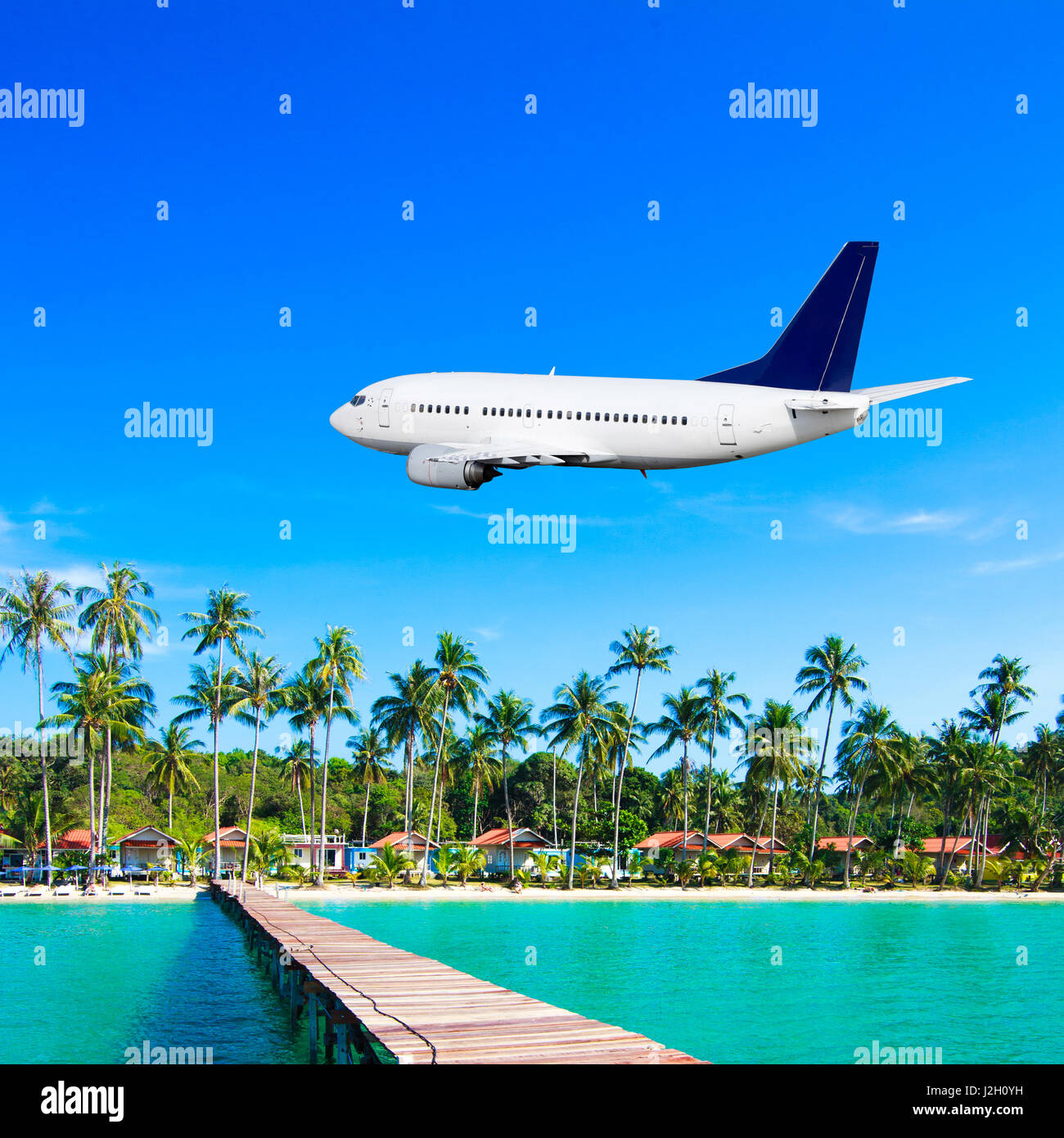 Jet plane over the tropical sea Stock Photo - Alamy