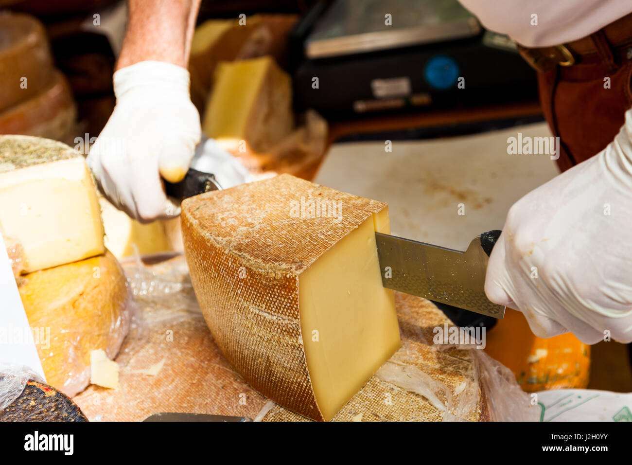 Man cutting piece of cheese Stock Photo - Alamy