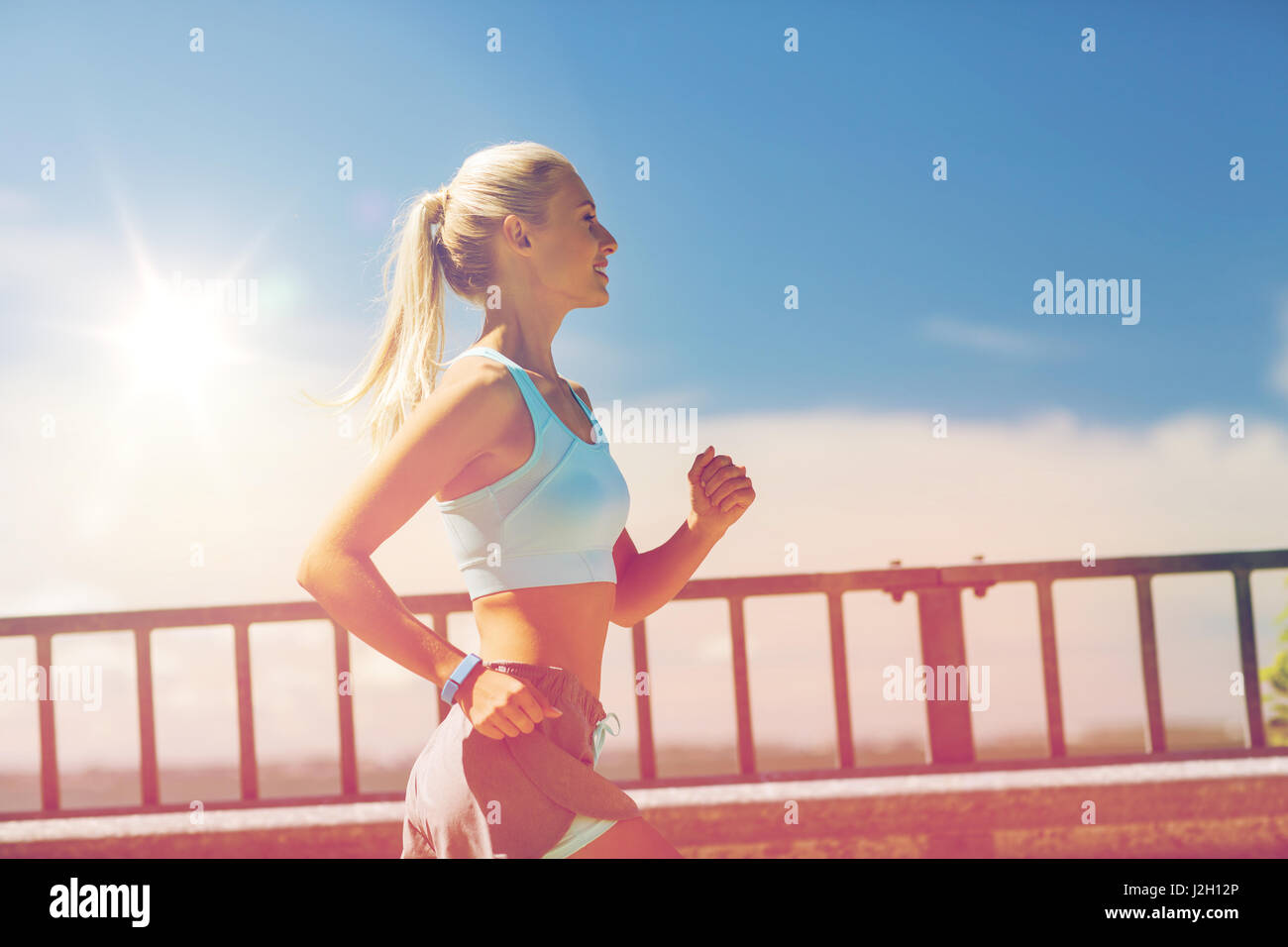 smiling young woman running outdoors Stock Photo - Alamy