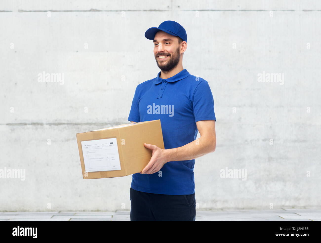 happy delivery man with parcel box Stock Photo - Alamy