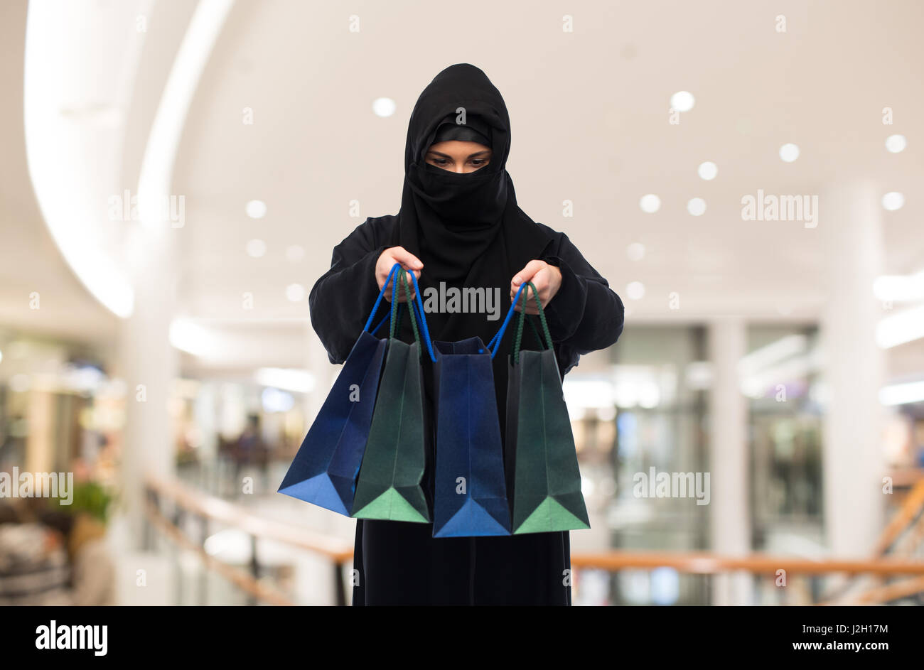 muslim woman in hijab with shopping bags Stock Photo - Alamy