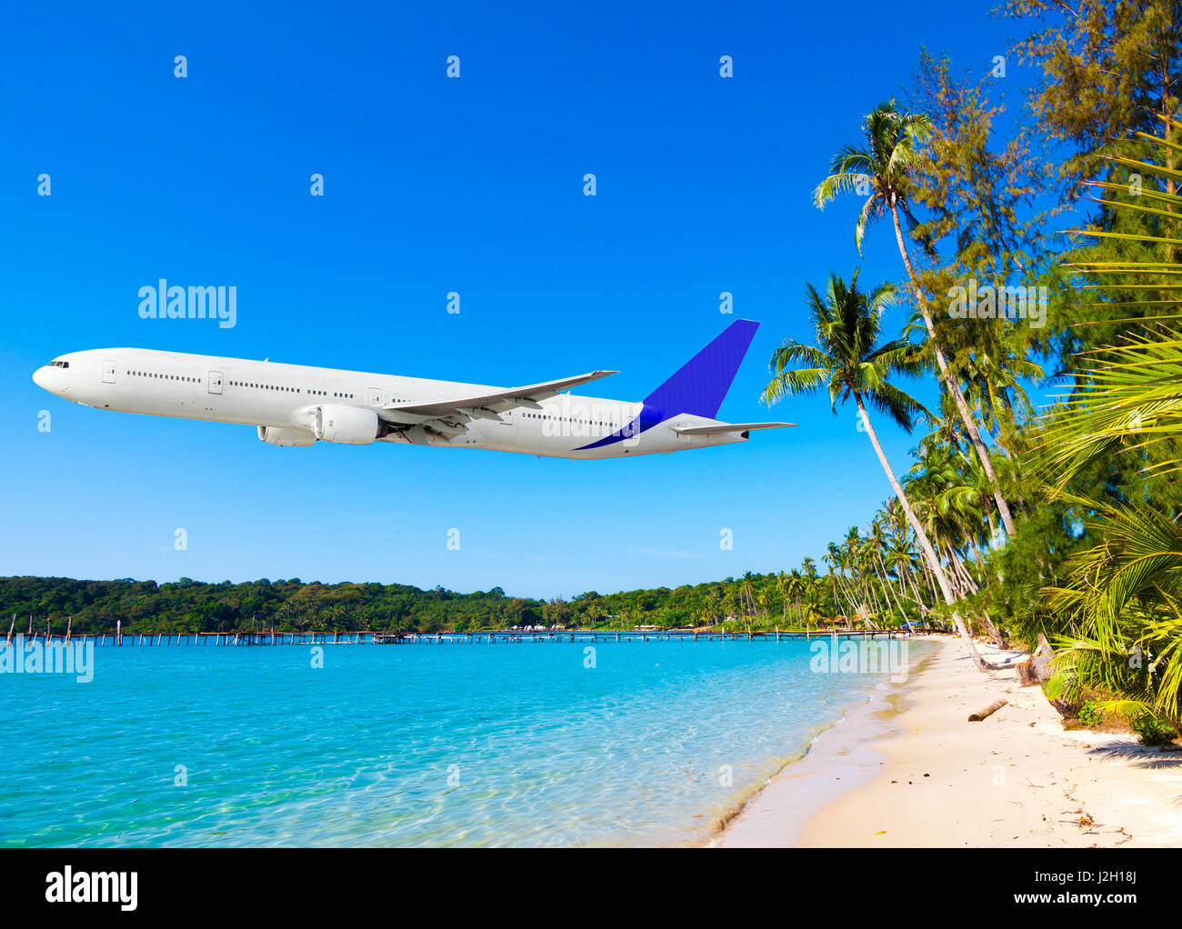 Jet plane over the tropical sea Stock Photo - Alamy