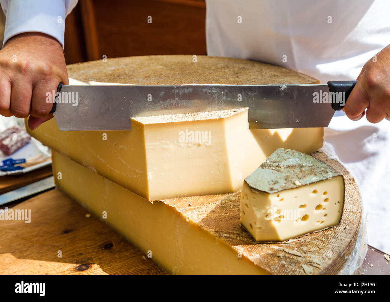 Man cutting piece of cheese Stock Photo - Alamy