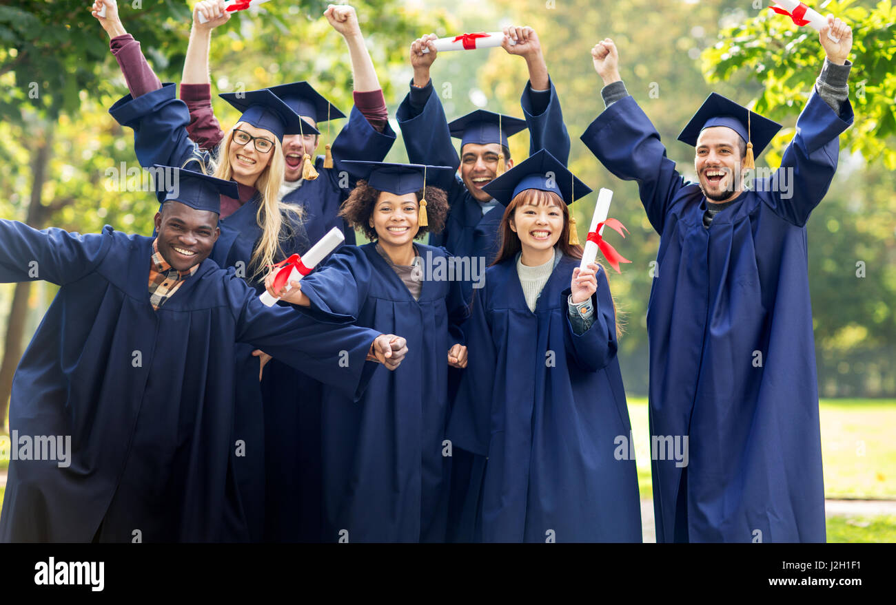 happy students in mortar boards with diplomas Stock Photo - Alamy