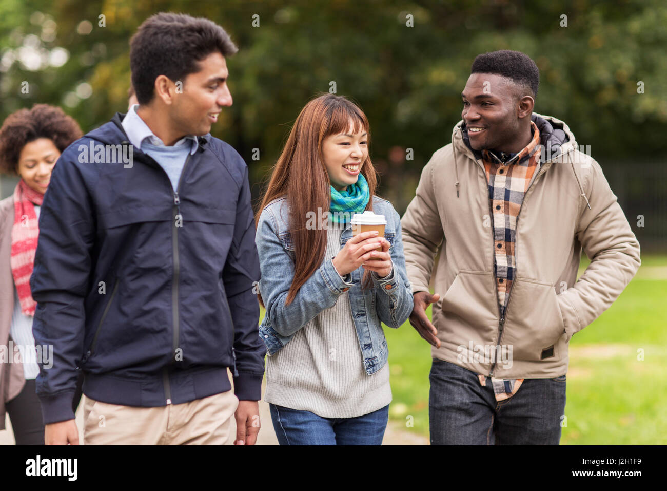 happy friends walking along autumn park Stock Photo - Alamy