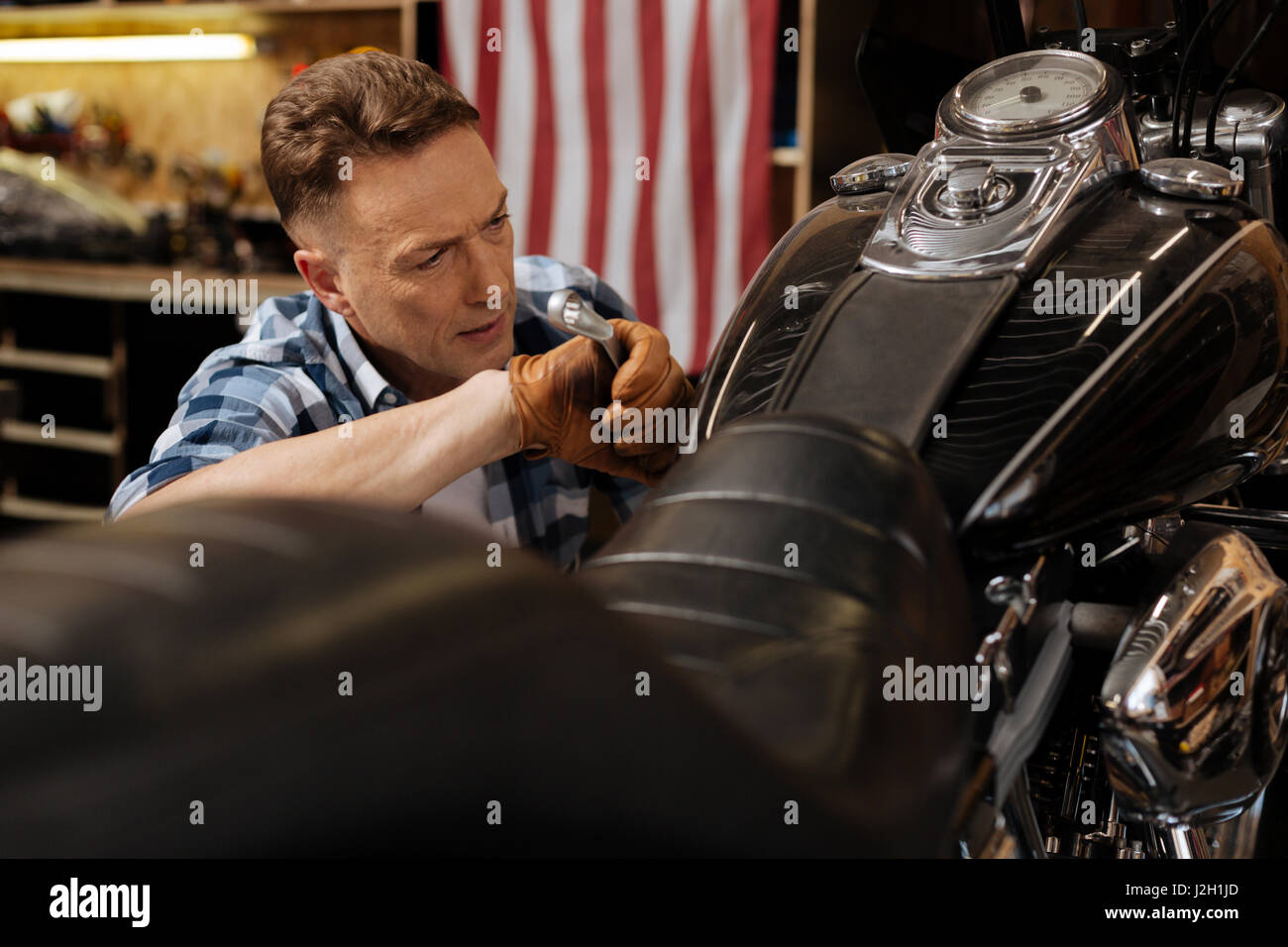 Precise good mechanic fixing the bolt Stock Photo - Alamy