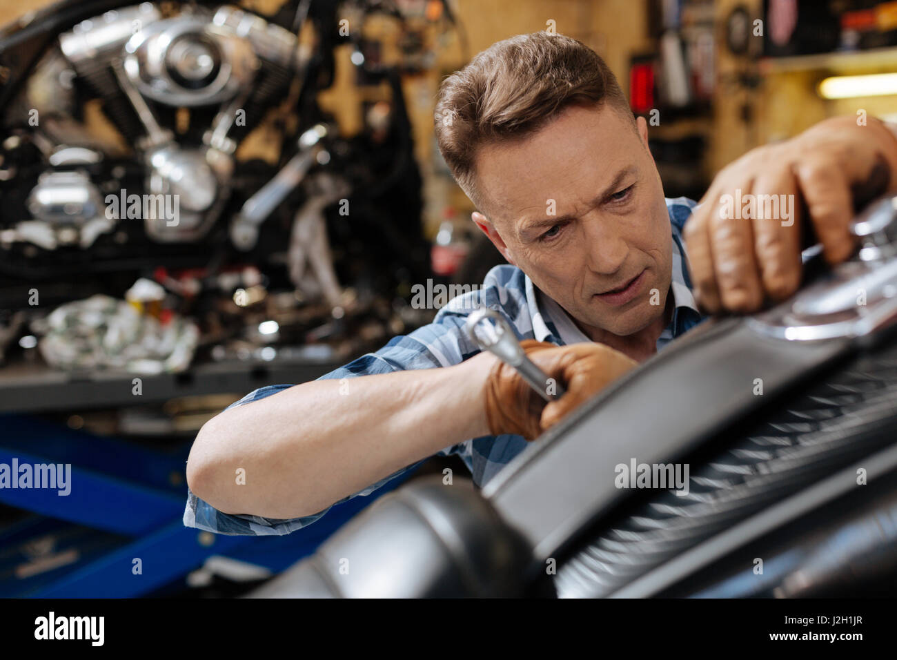 Professional concerned maintenance man fixing some problems Stock Photo ...