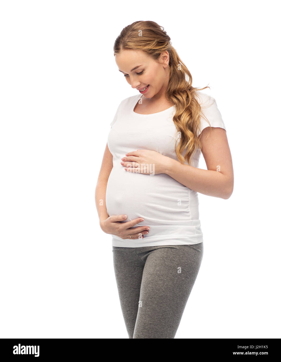happy pregnant woman touching her big belly Stock Photo - Alamy