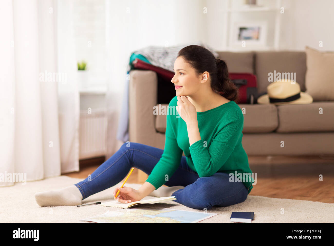 woman with notebook and travel map at home Stock Photo - Alamy