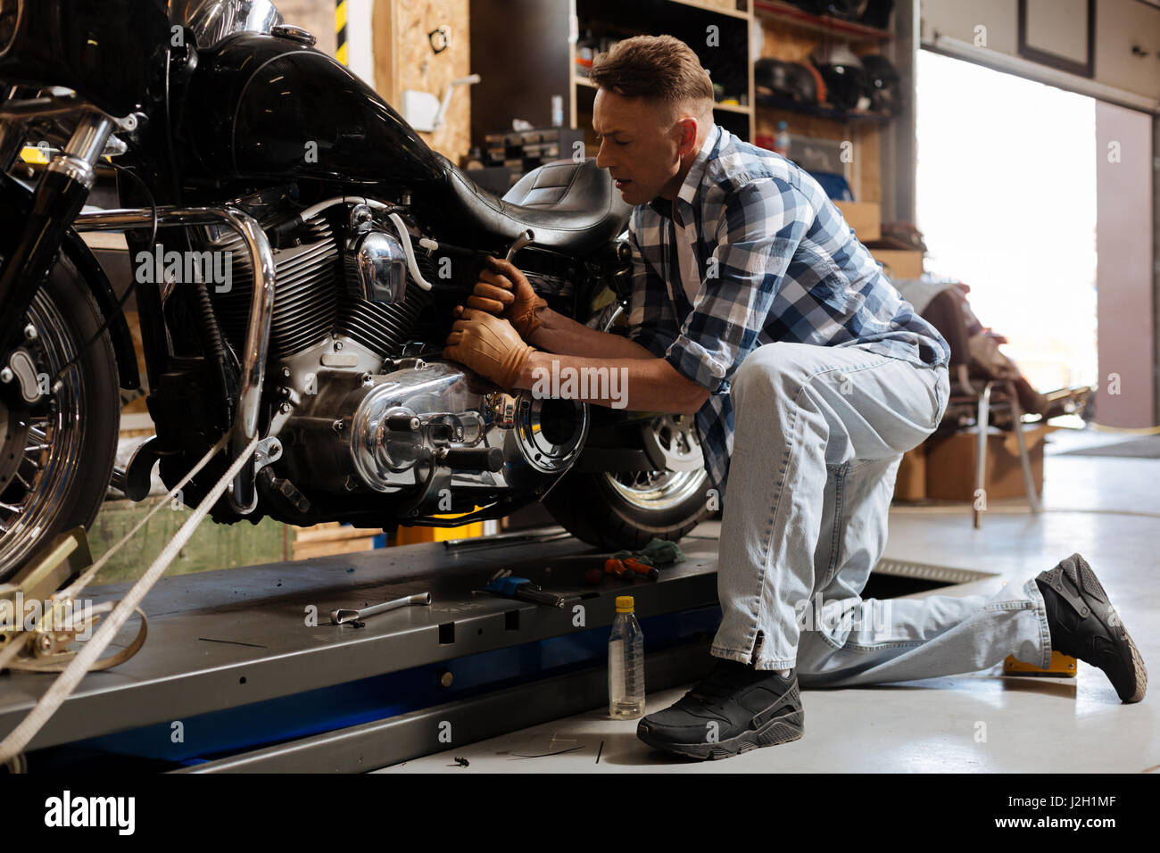 Able licensed mechanic performing maintenance of a bike Stock Photo - Alamy