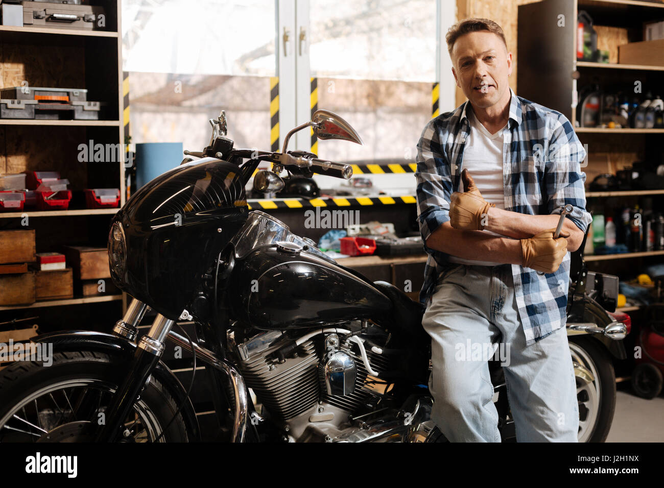 Handsome skilled mechanic at his workplace Stock Photo - Alamy