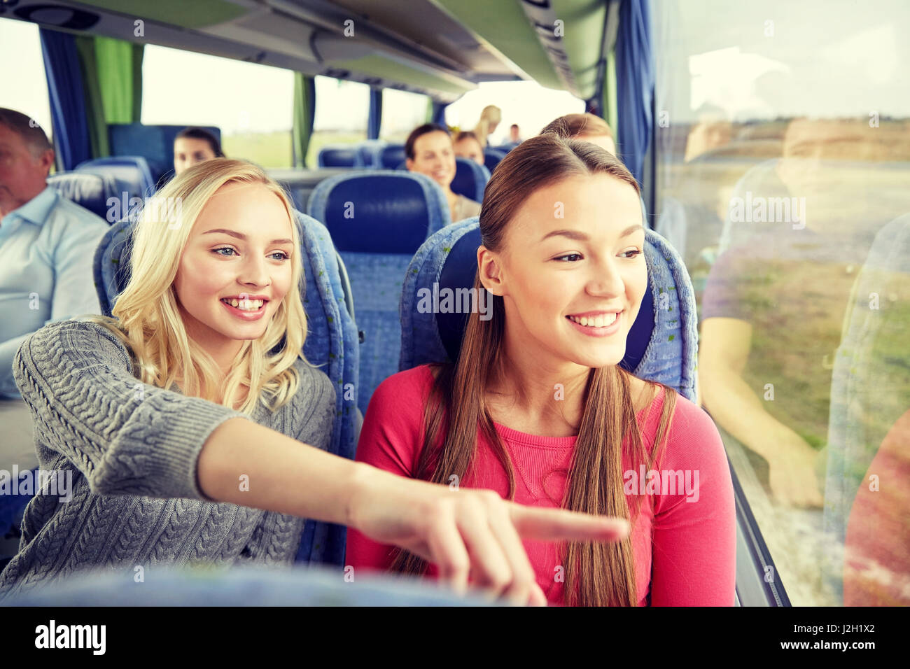 happy young women riding in travel bus Stock Photo - Alamy